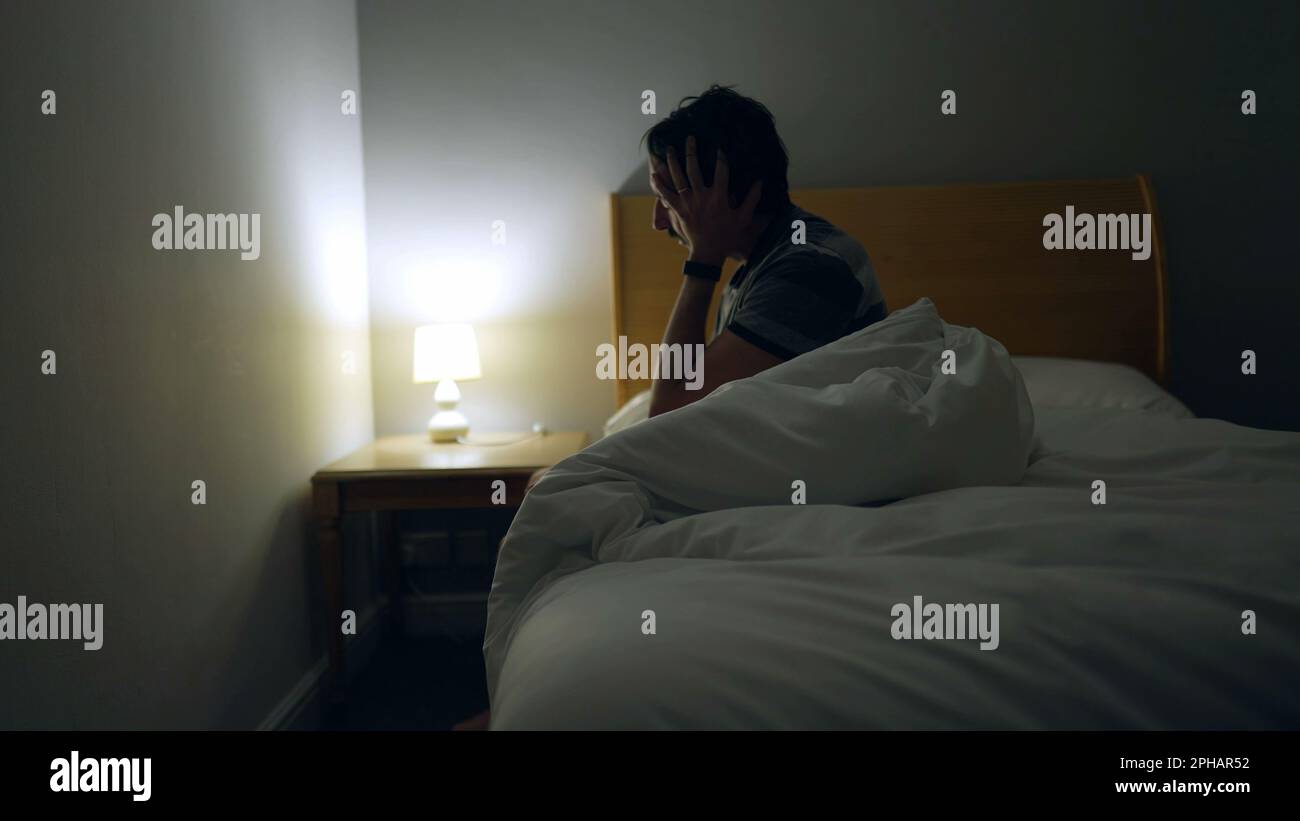 Man waking up in the middle of the night unable to sleep. person ...
