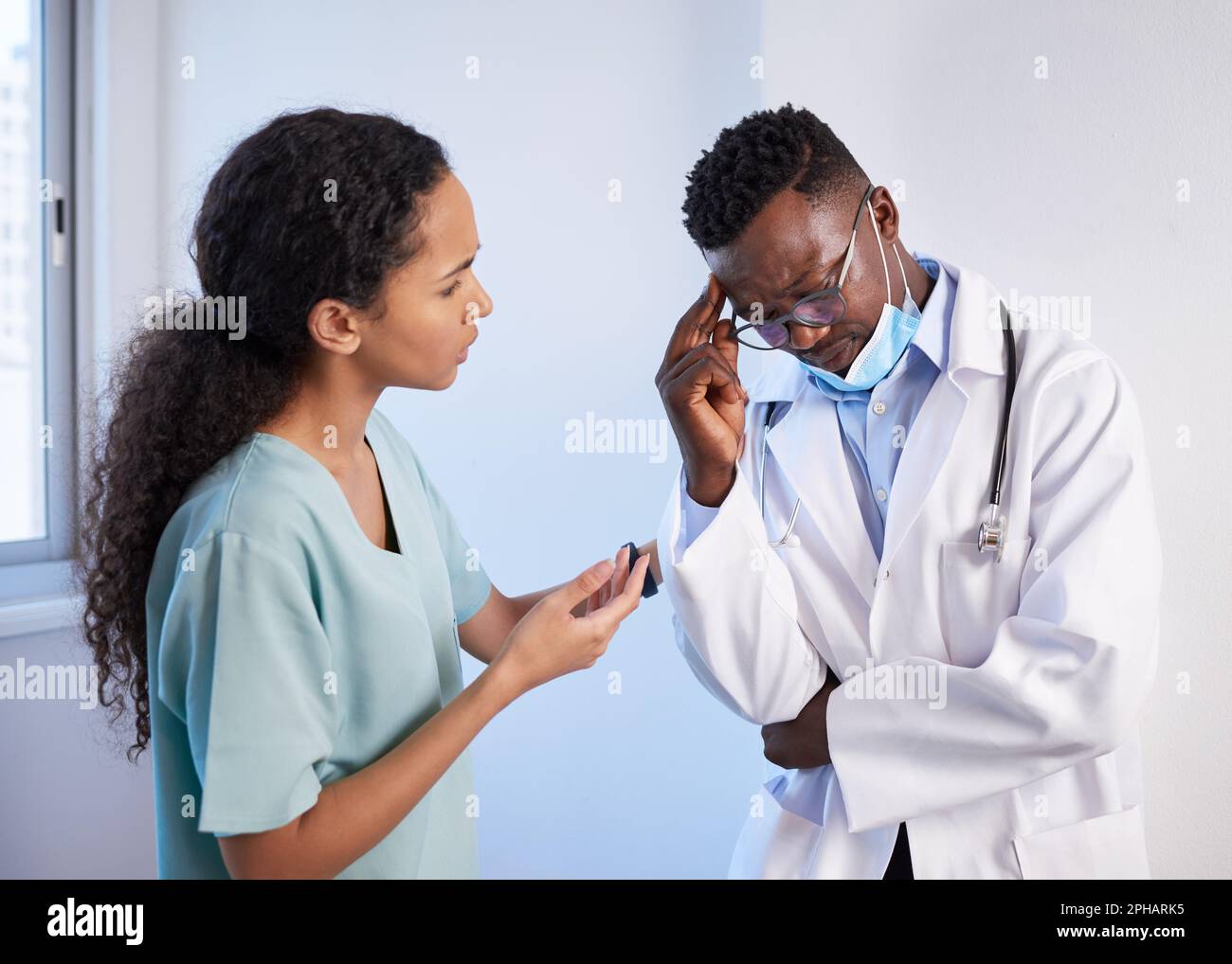 Nurse in scrubs comforts doctor after unsuccessful surgery, burnout ...