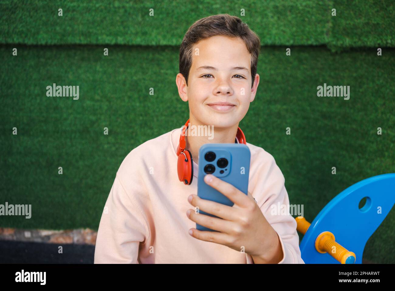 Outdoor portrait of happy teen boy 12-14 year old with cell phone ...