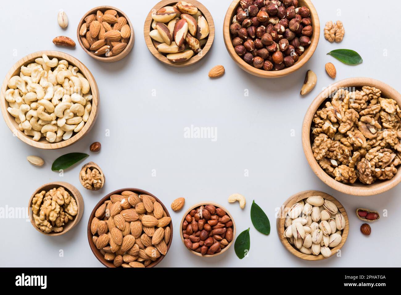 mixed nuts in wooden bowl. Mix of various nuts on colored background ...