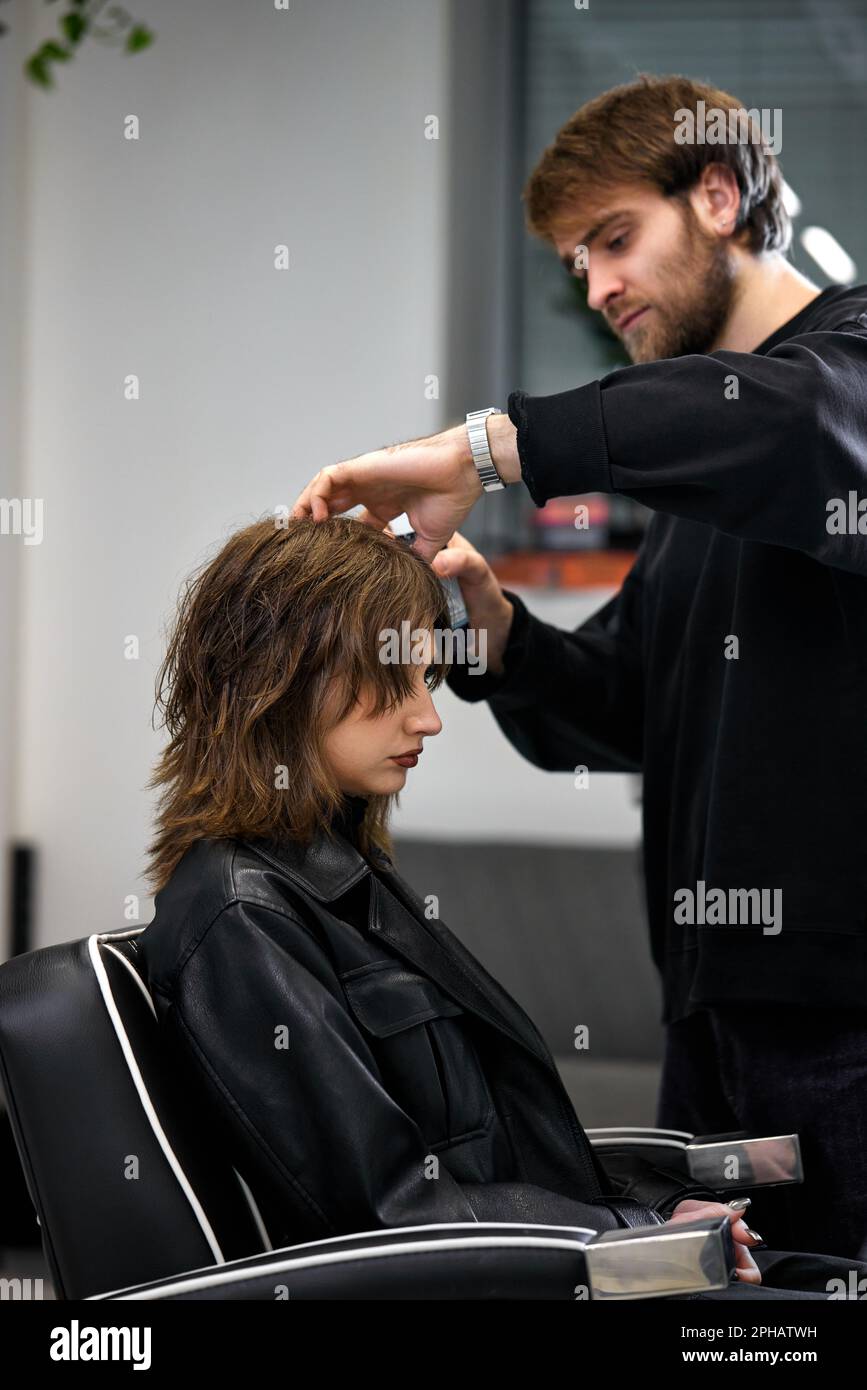 male hairdresser working with client at hair salon Stock Photo - Alamy