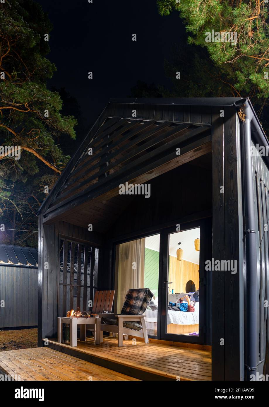 Cottage barnhouse for relaxation made of dark wood at night in the ...