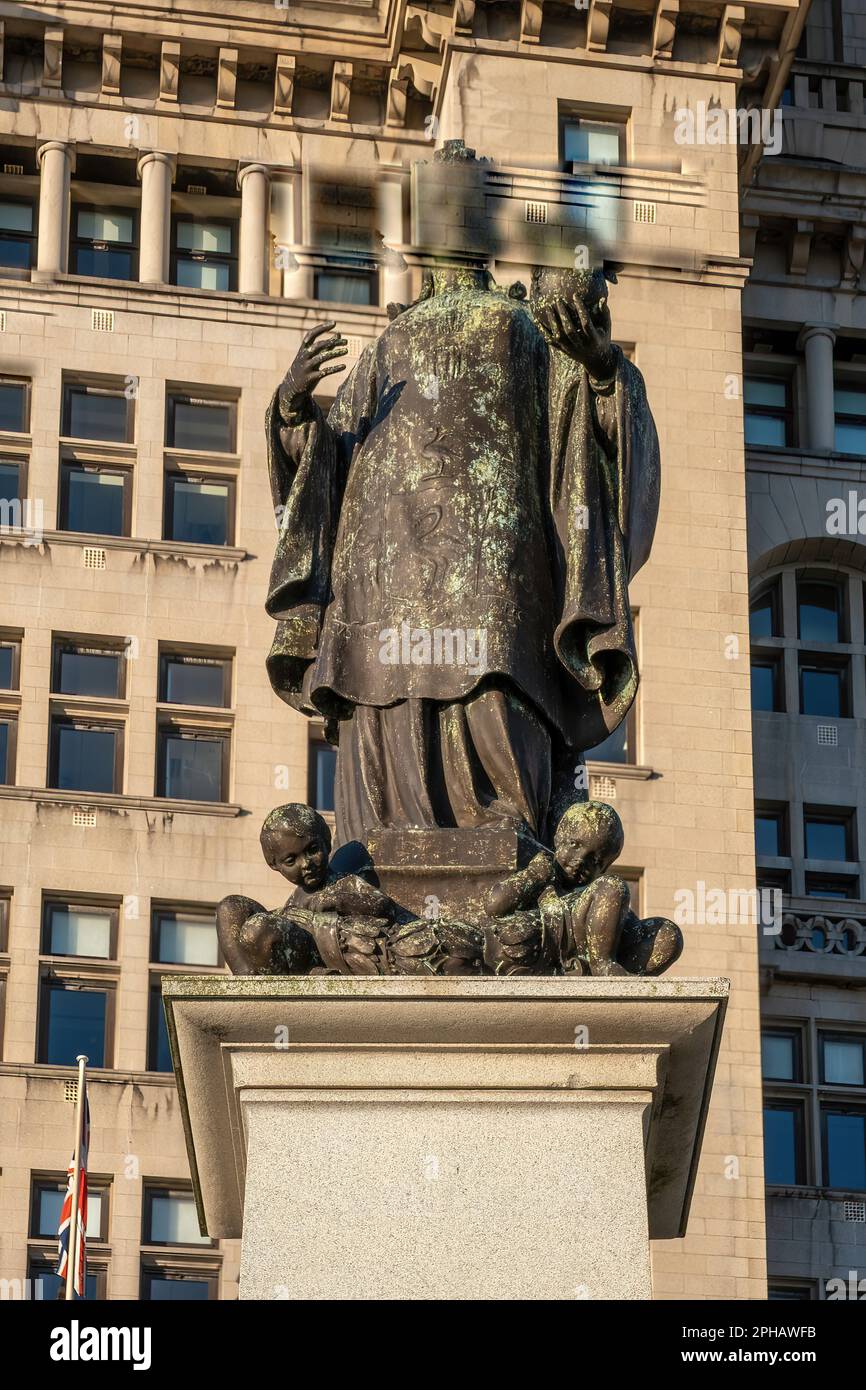 An outdoor scene featuring a statue of a person in a public square in ...