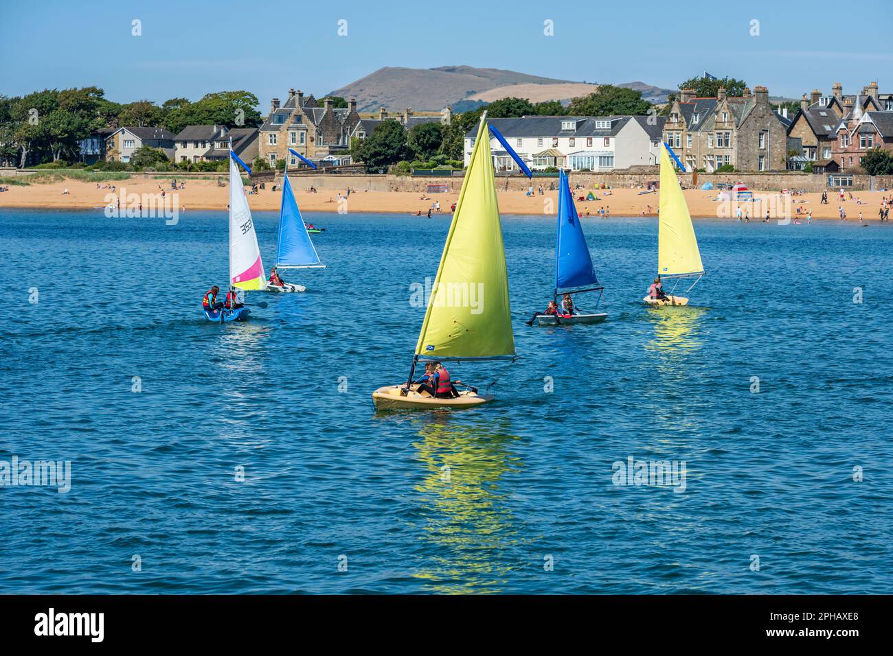 Youngsters enjoying the summer sunshine dinghy sailing in Elie harbour ...