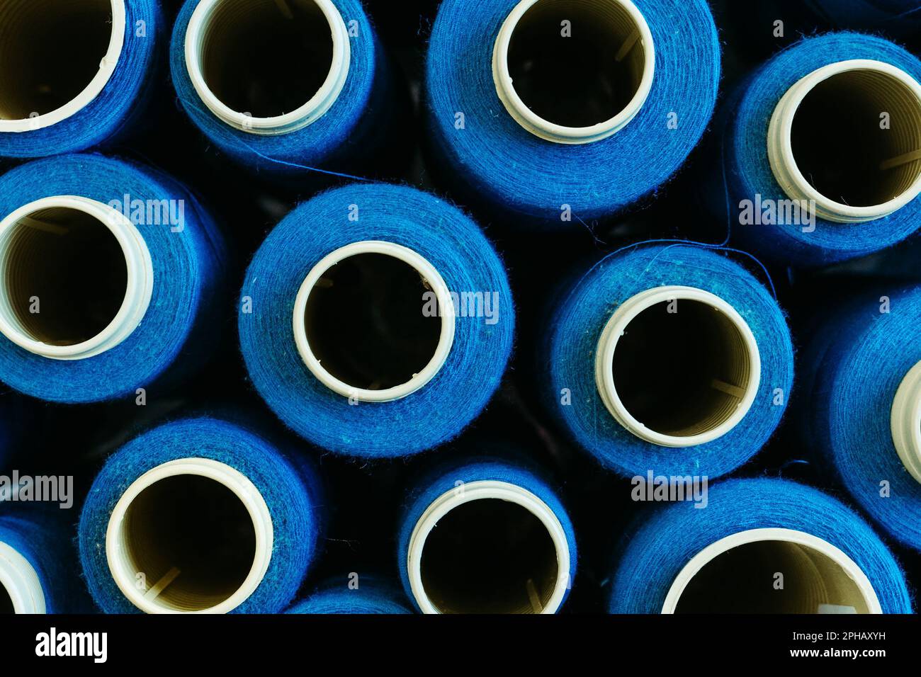 A high-resolution image of a set of spools of blue thread Stock Photo ...