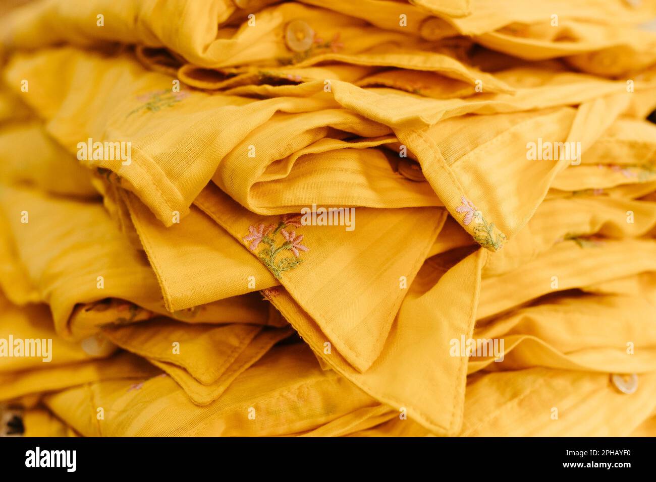 A vibrant and colorful scene featuring a stack of yellow fabric with ...