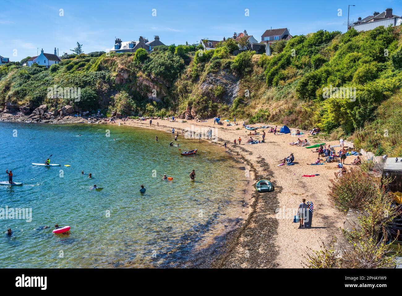 Elevated view looking across sandy beach at picturesque coastal town of ...