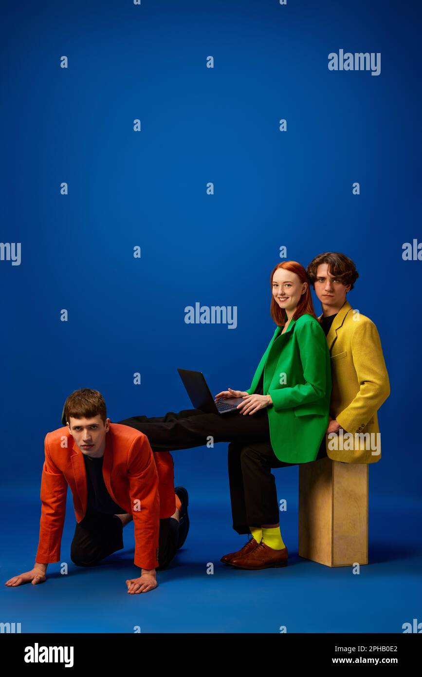 Group of young people wearing stylish clothes doing their job over blue ...