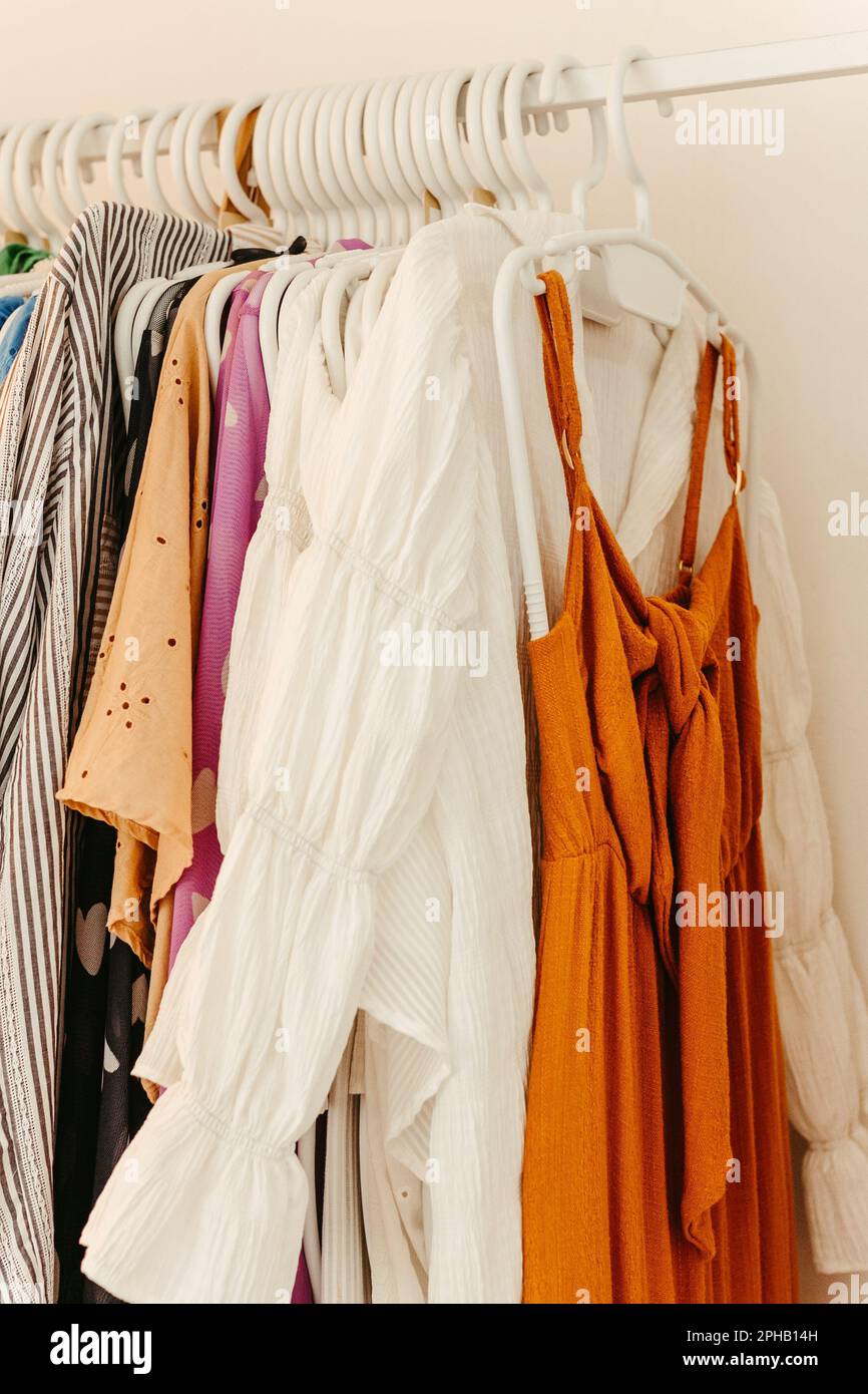 A selection of stylish clothing items is displayed on a wall-mounted ...