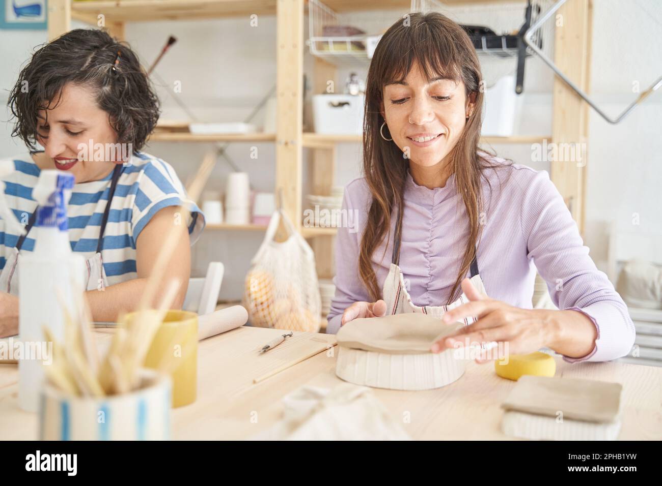 Women making handmade pottery in a pottery class. Handicraft and ...