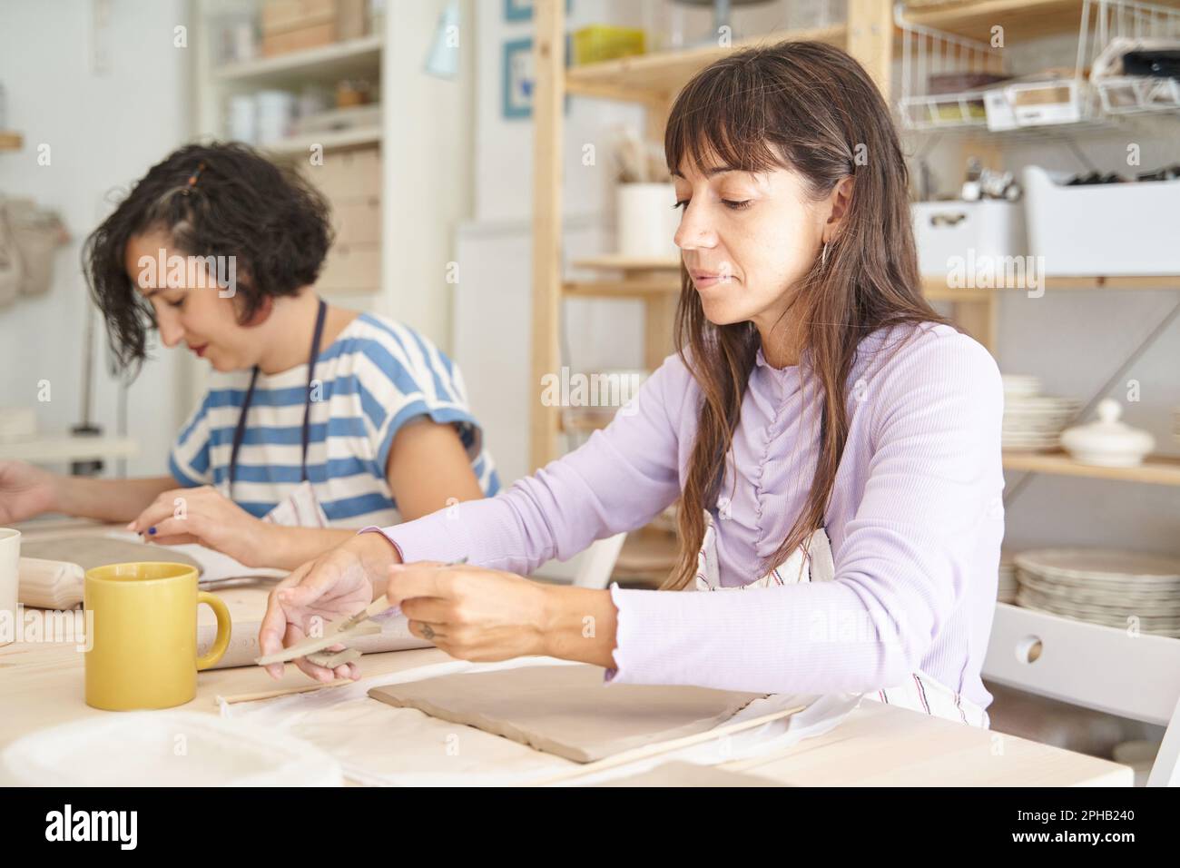 Women making handmade pottery in a pottery class. Handicraft and ...