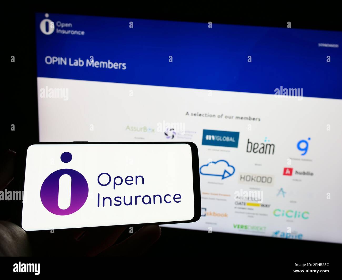 Person holding cellphone with logo of industry initiative Open ...