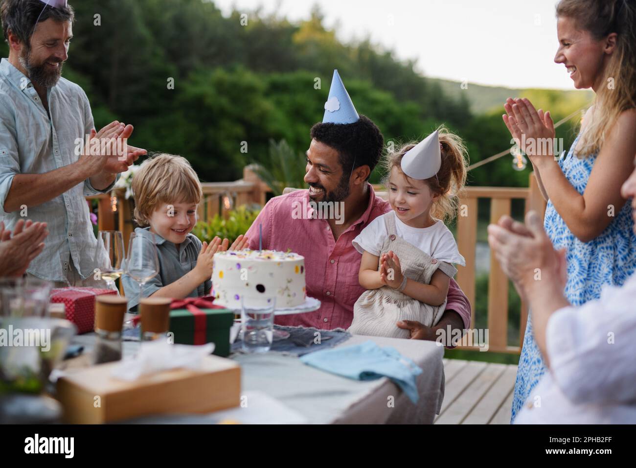 Multi generation family celebrating birthday and have garden party ...