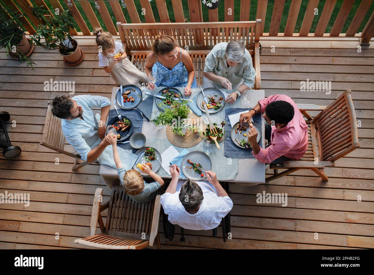 Top view of 3 generations family eating at barbecue party dinner on ...