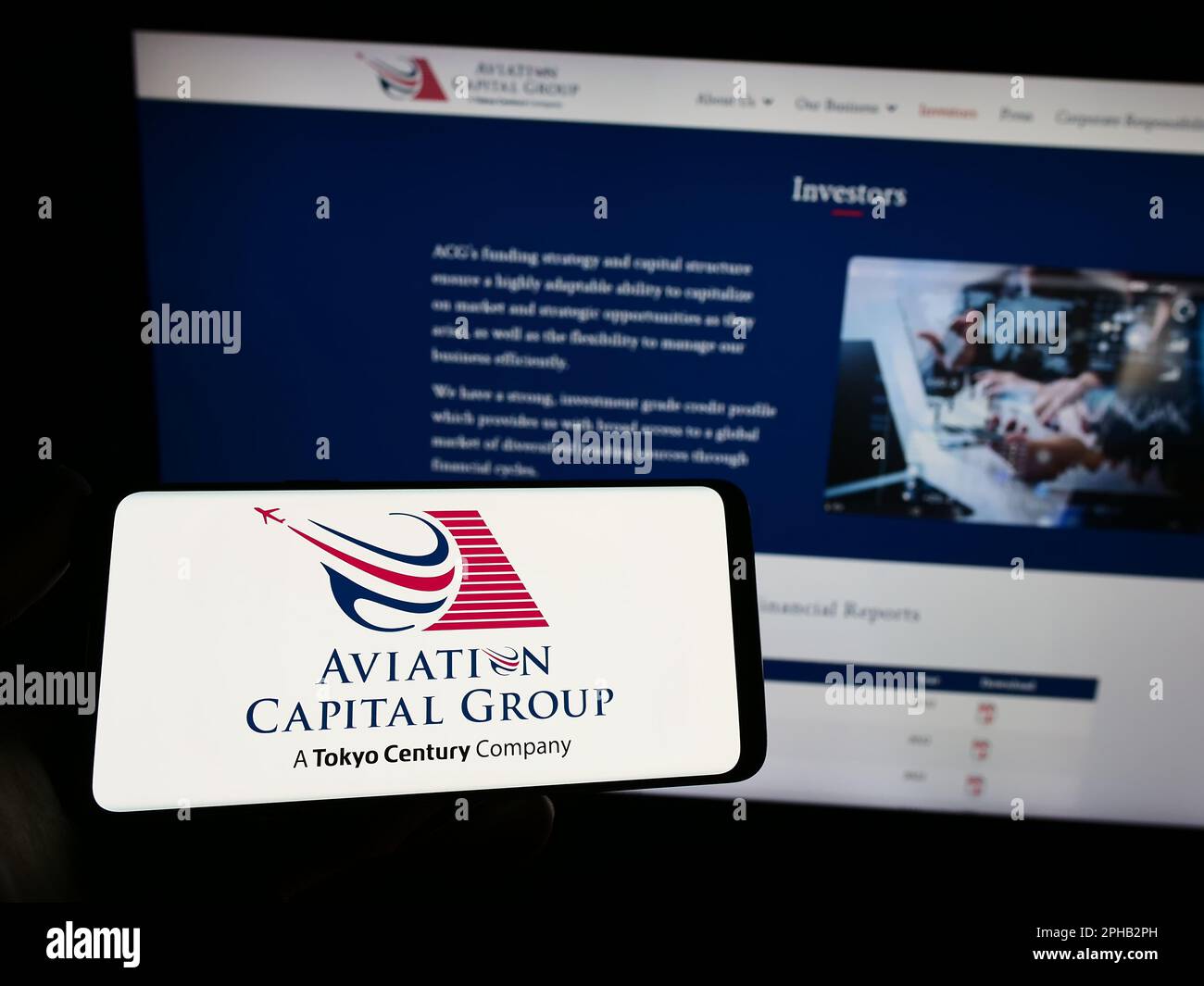 Person holding smartphone with logo of US leasing company Aviation ...