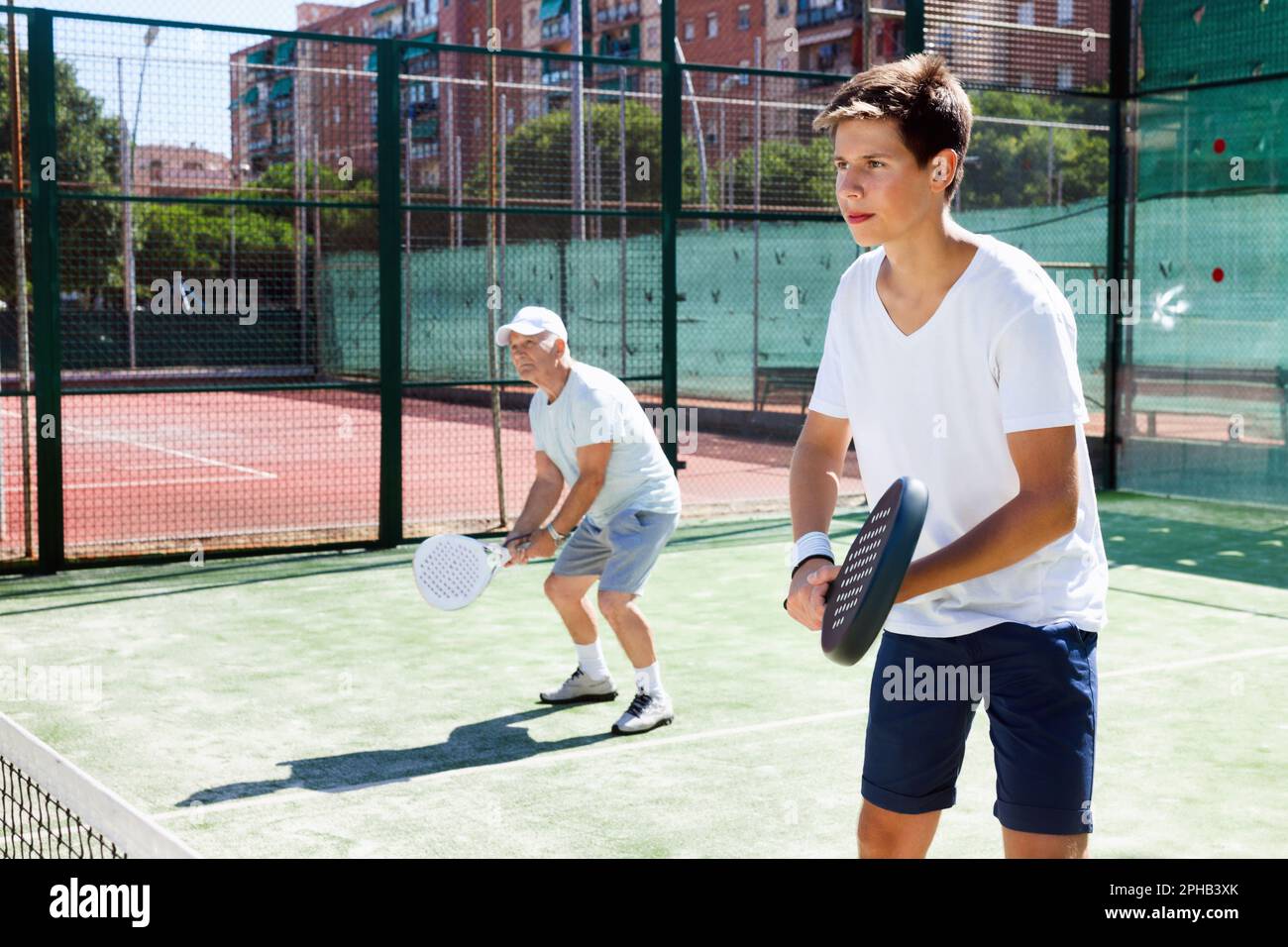padel players of different generations playing padel court Stock Photo ...