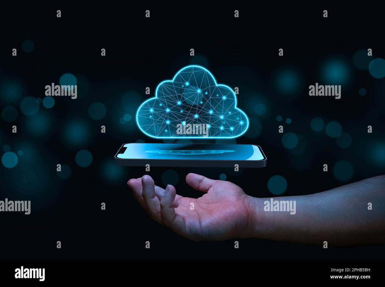 Hand holding smartphone with cloud computing concept on dark background ...