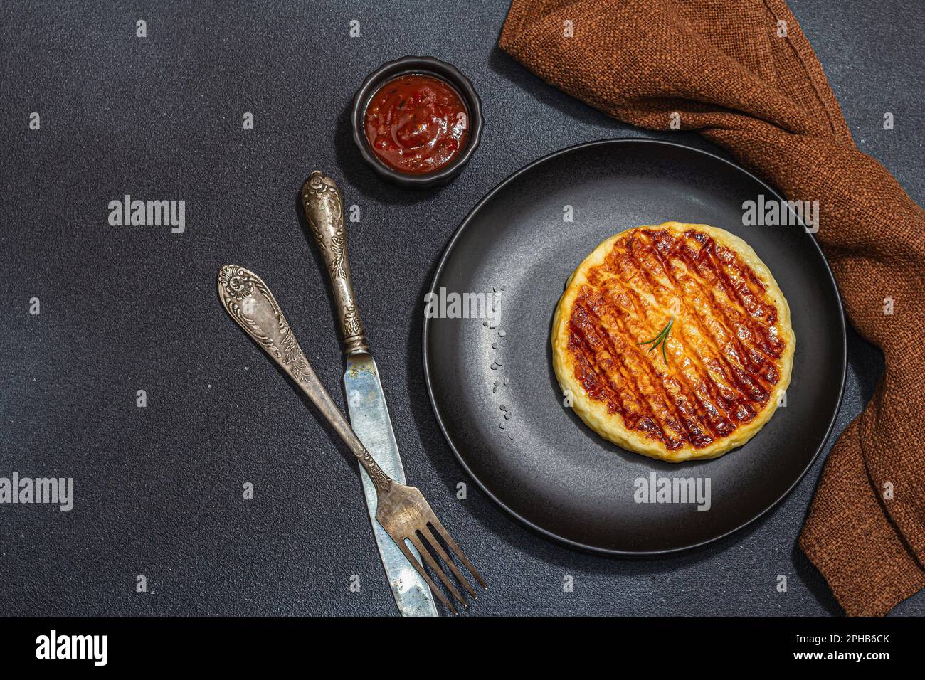 Grilled Halloumi cheese served on plate. Cutlery, traditional food for ...