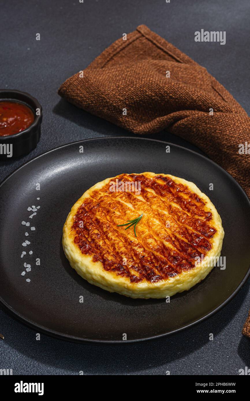 Grilled Halloumi cheese served on plate. Cutlery, traditional food for ...