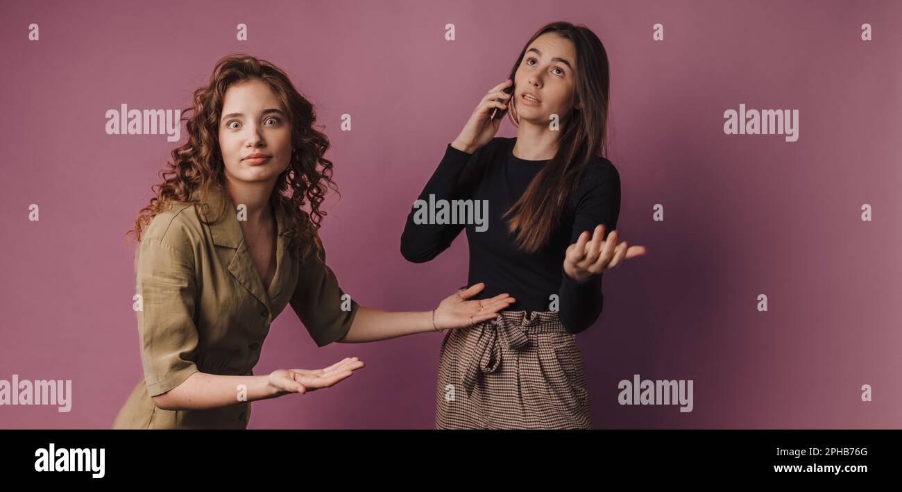 Studio shoot of two young women, one calling with mobile phone Stock ...