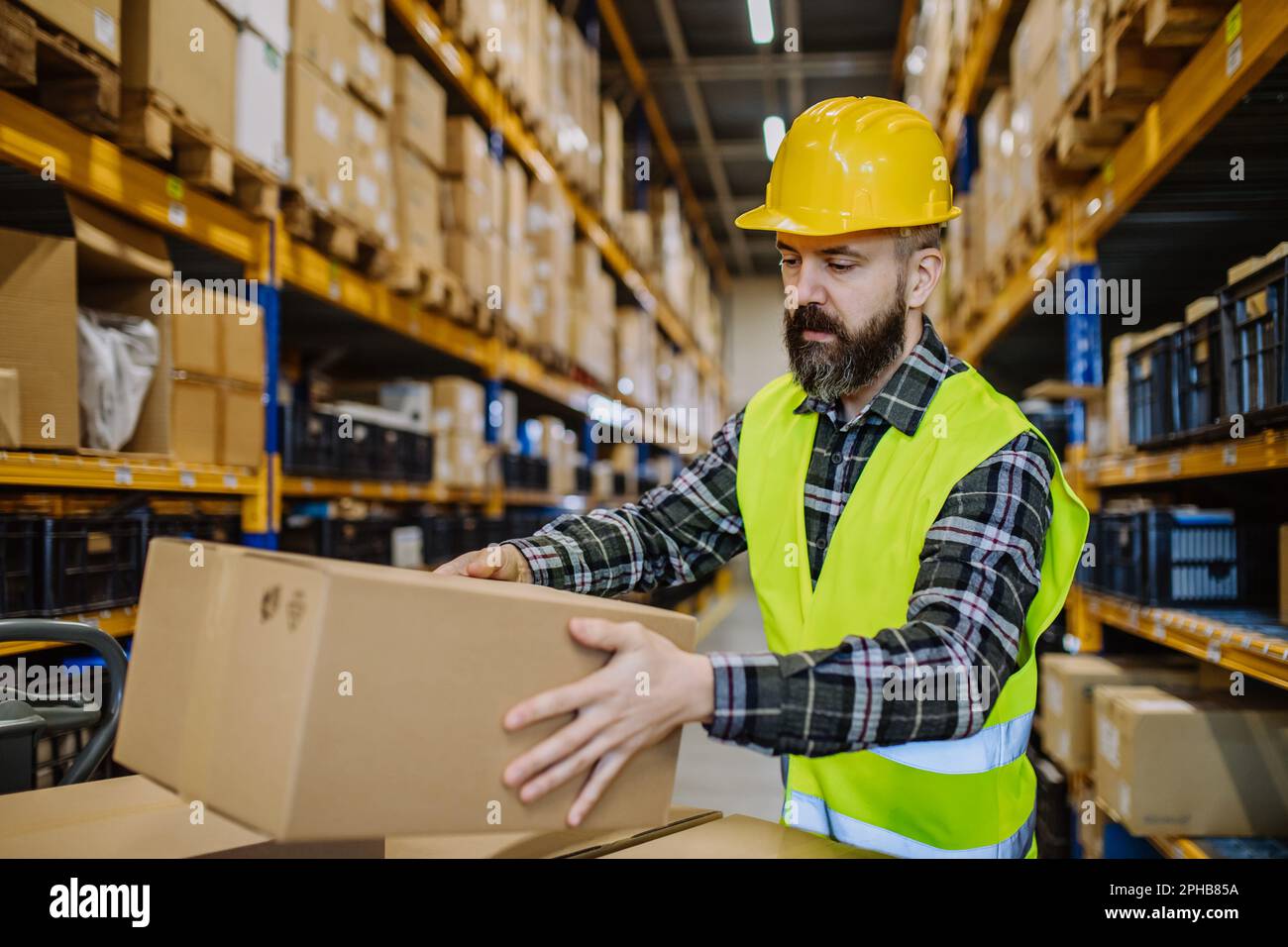 Warehouse worker stocking goods in a warehouse Stock Photo - Alamy