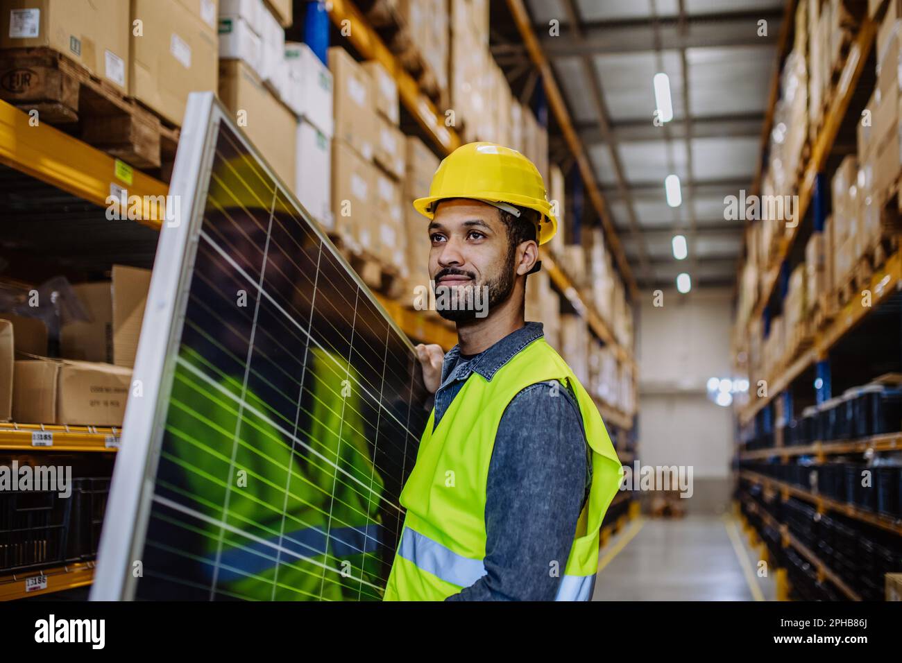 Portrait of warehouse worker carring solar panel Stock Photo - Alamy
