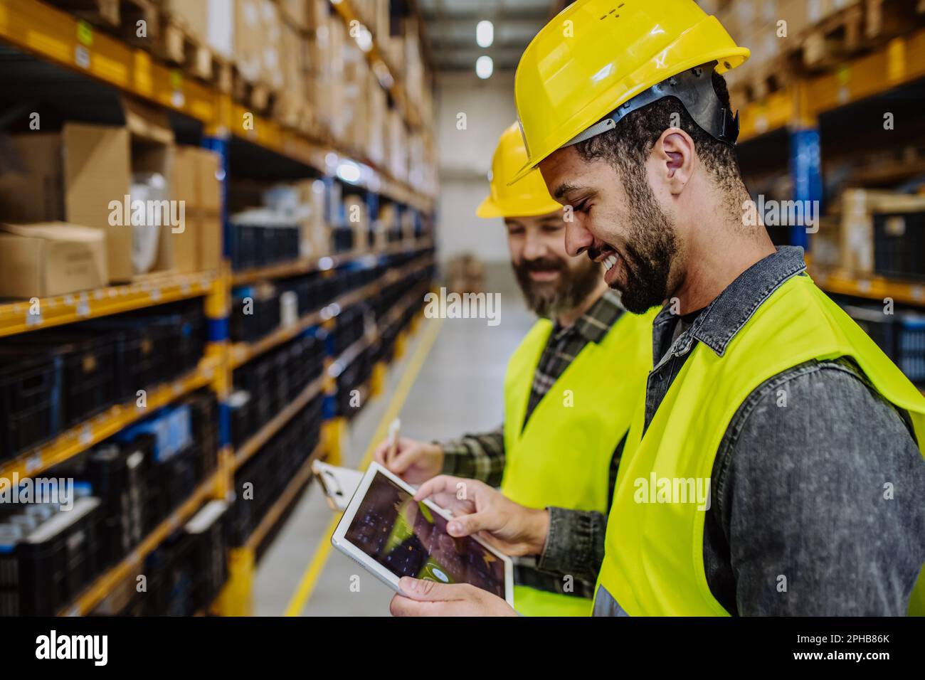 Warehouse workers checking stuff in warehouse with digital system in ...