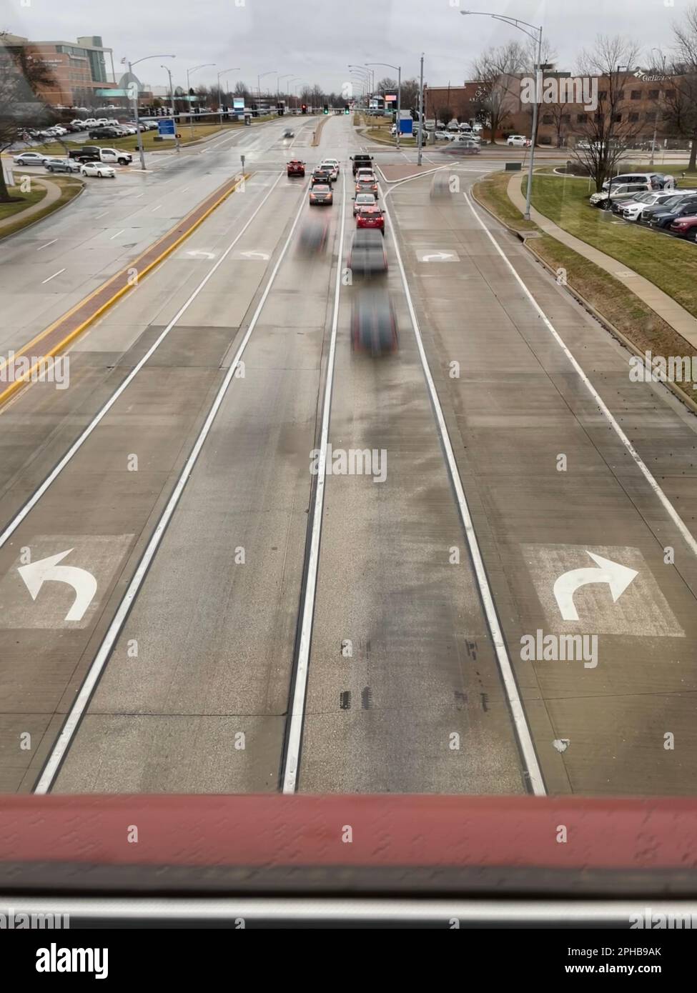 A busy urban street with several cars driving in one direction Stock ...
