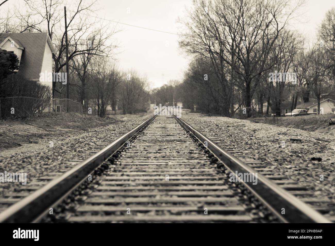 A picturesque rural village with a vintage railroad track running ...