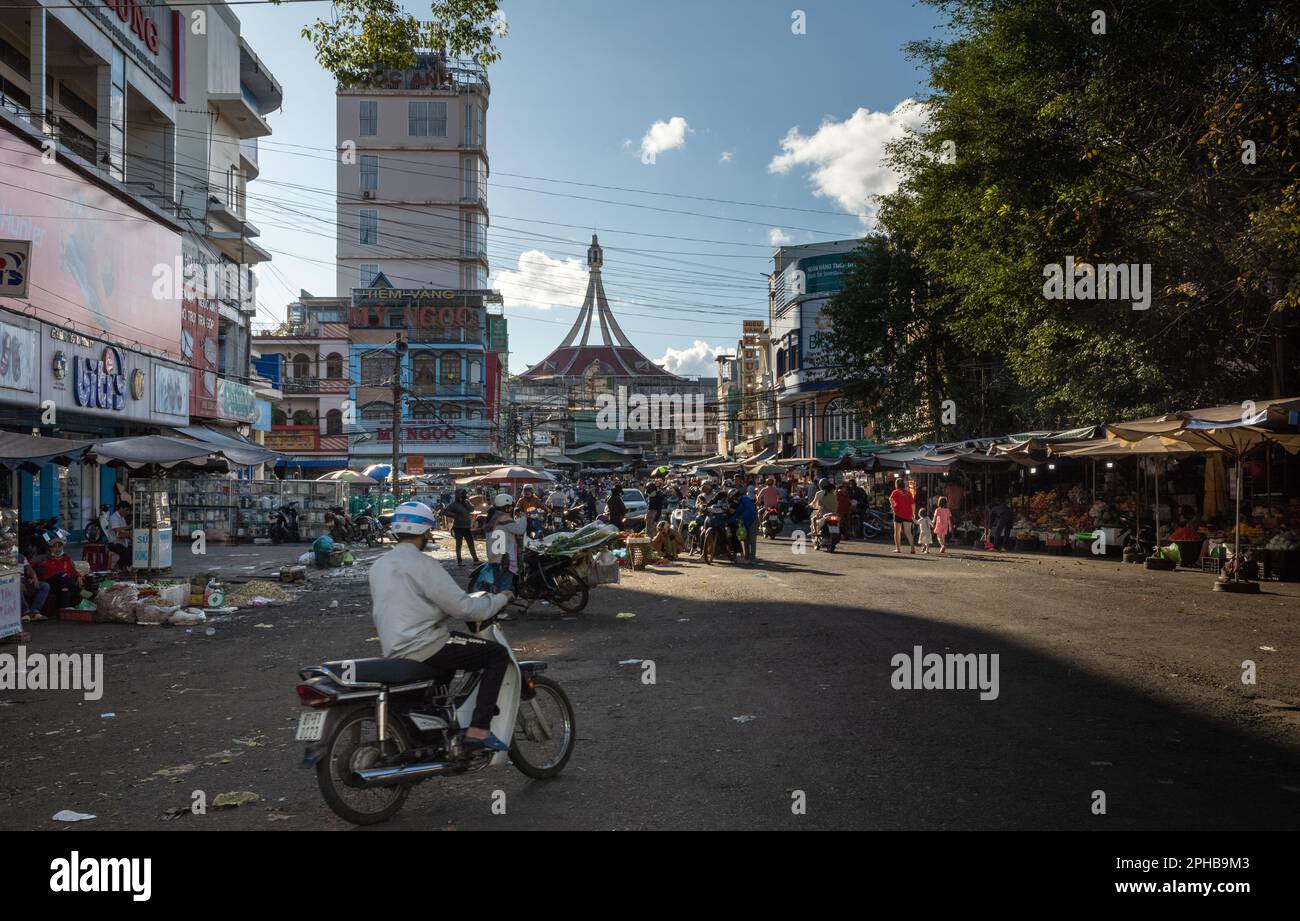 A man rides a motorcycle towards the crowded streets outside the ...