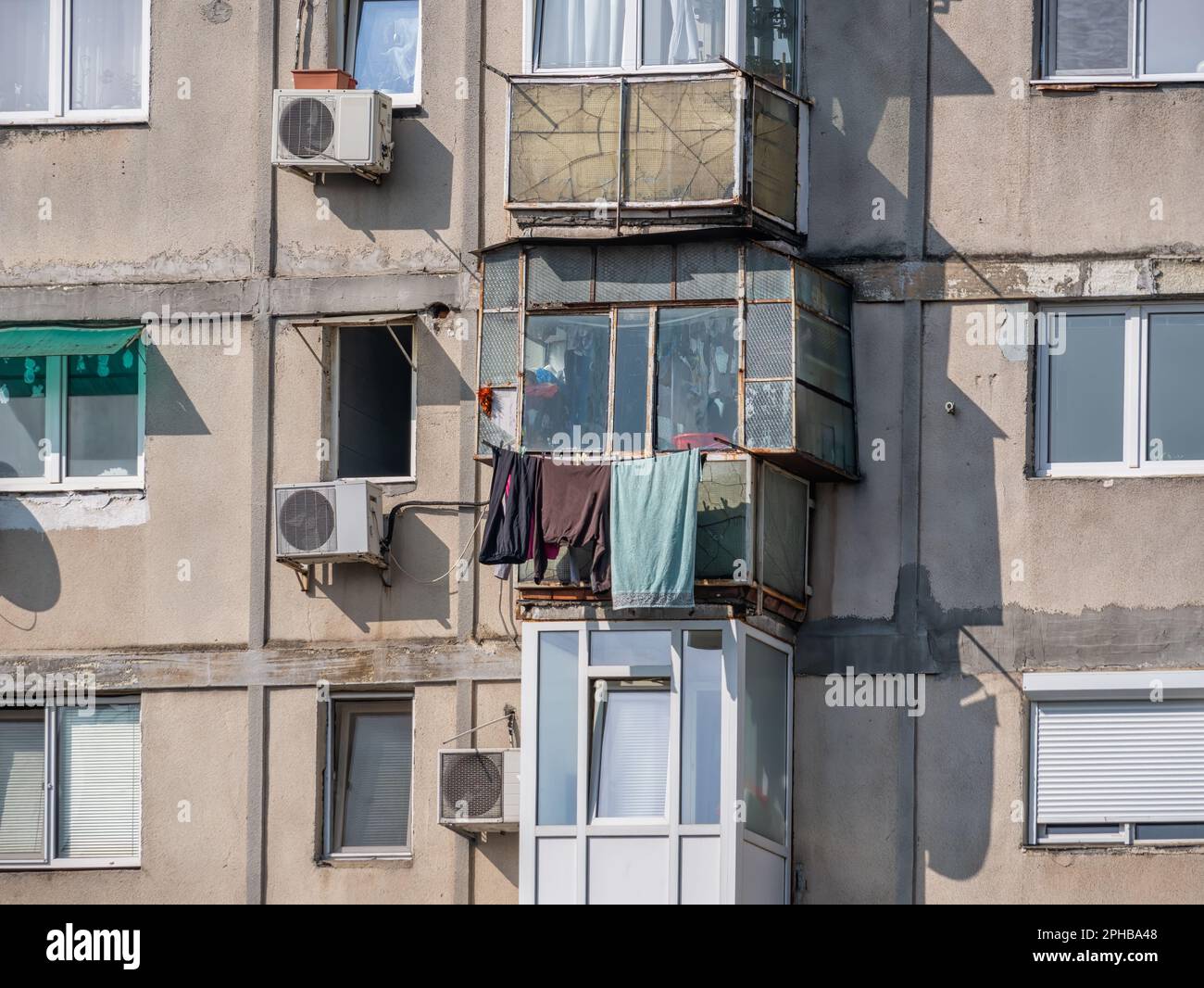 Worn out apartment building from the communist era against blue sky in ...