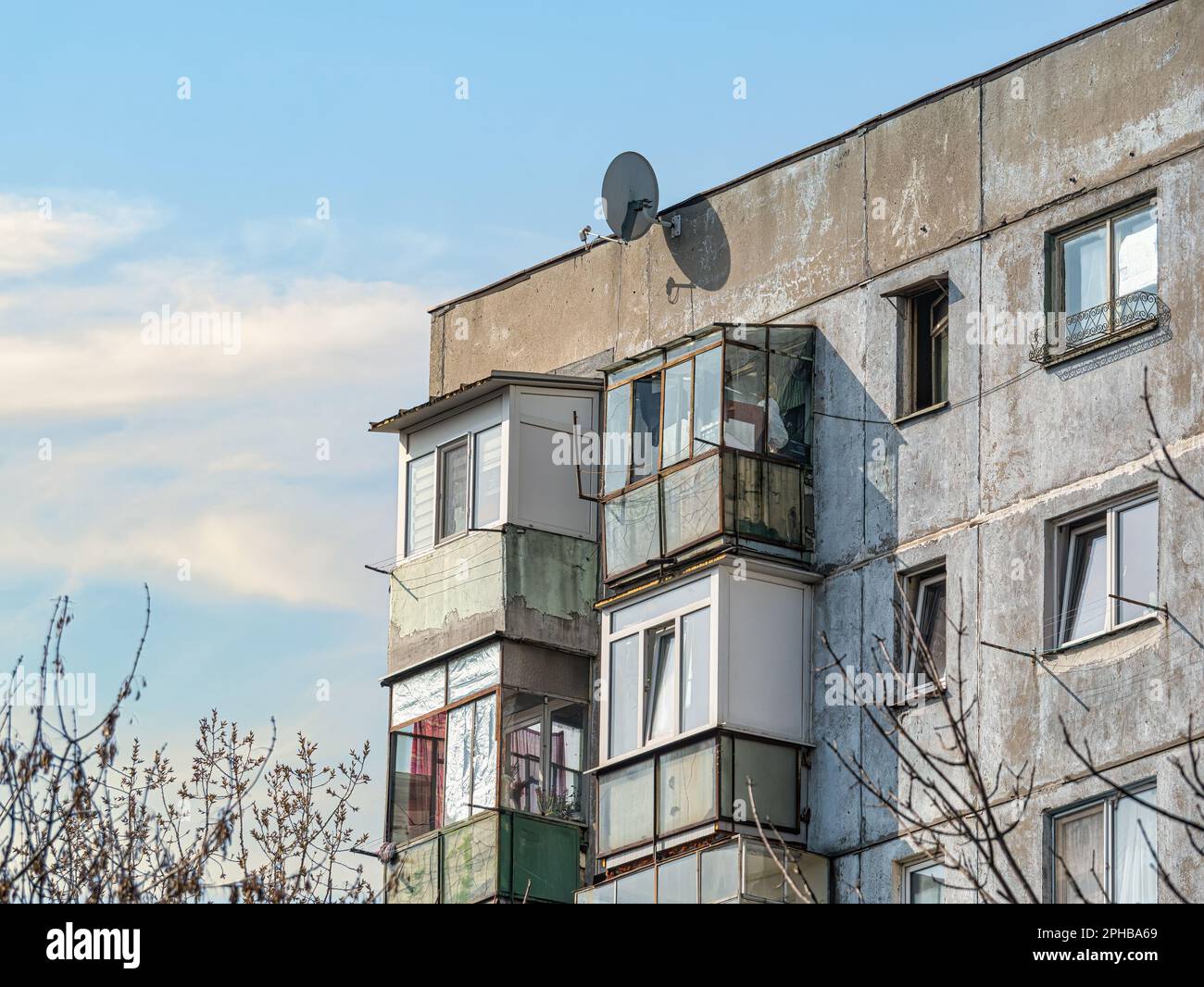 Worn out apartment building from the communist era against blue sky in ...