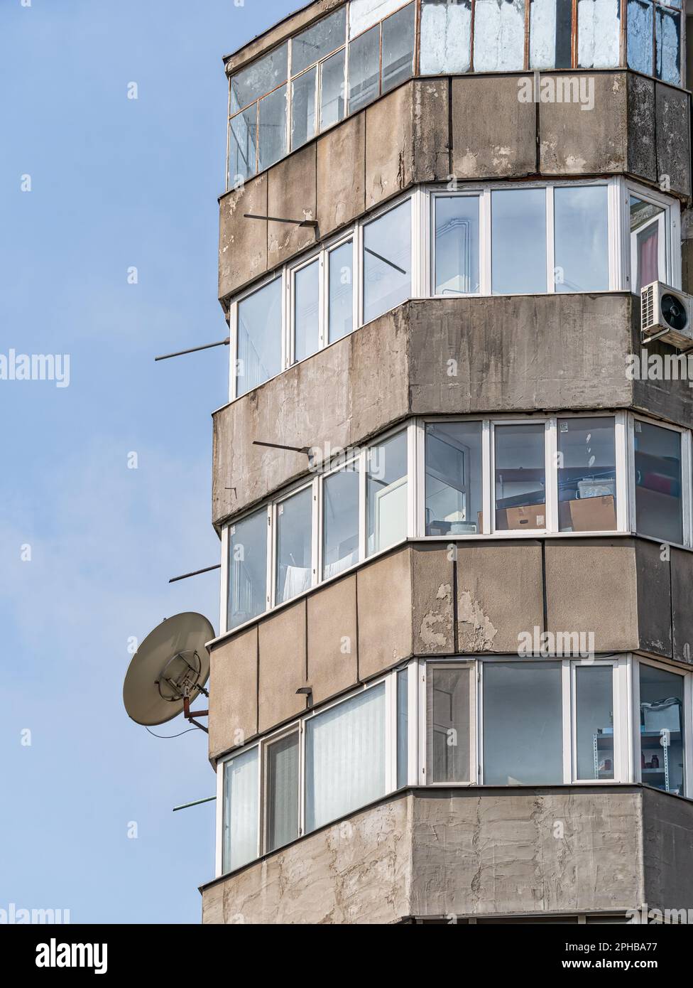Worn out apartment building from the communist era against blue sky in ...