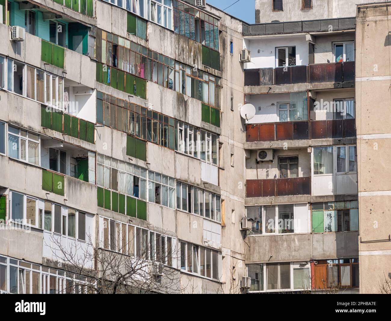 Worn out apartment building from the communist era against blue sky in ...