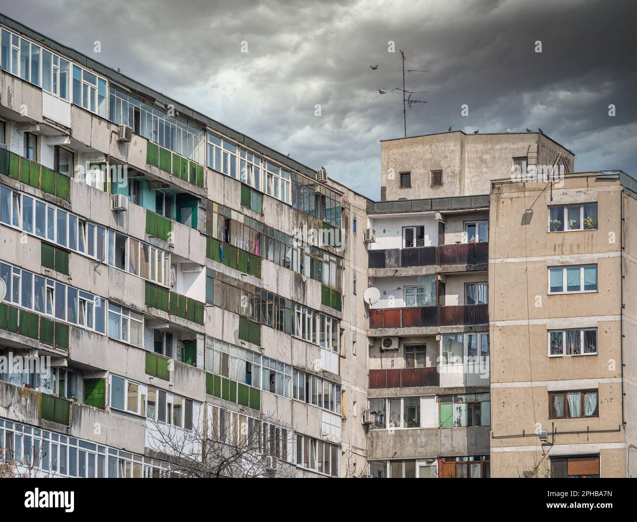 Worn out apartment building from the communist era against blue sky in ...