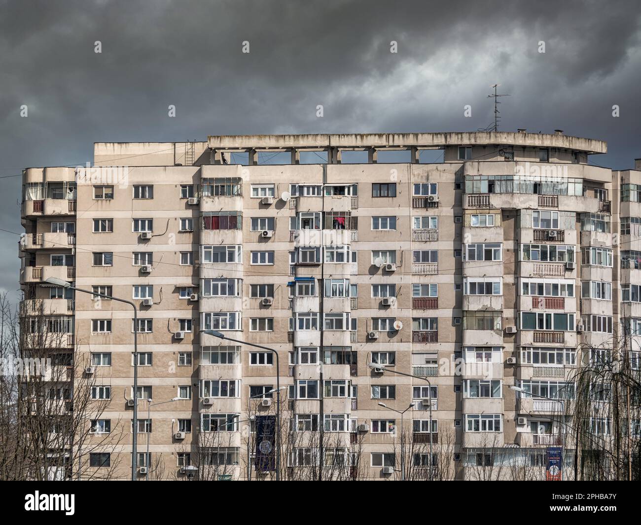 Worn out apartment building from the communist era against blue sky in ...