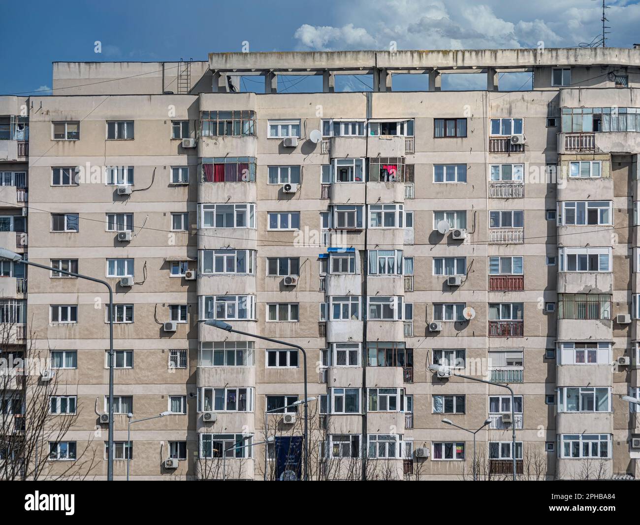 Worn out apartment building from the communist era against blue sky in ...