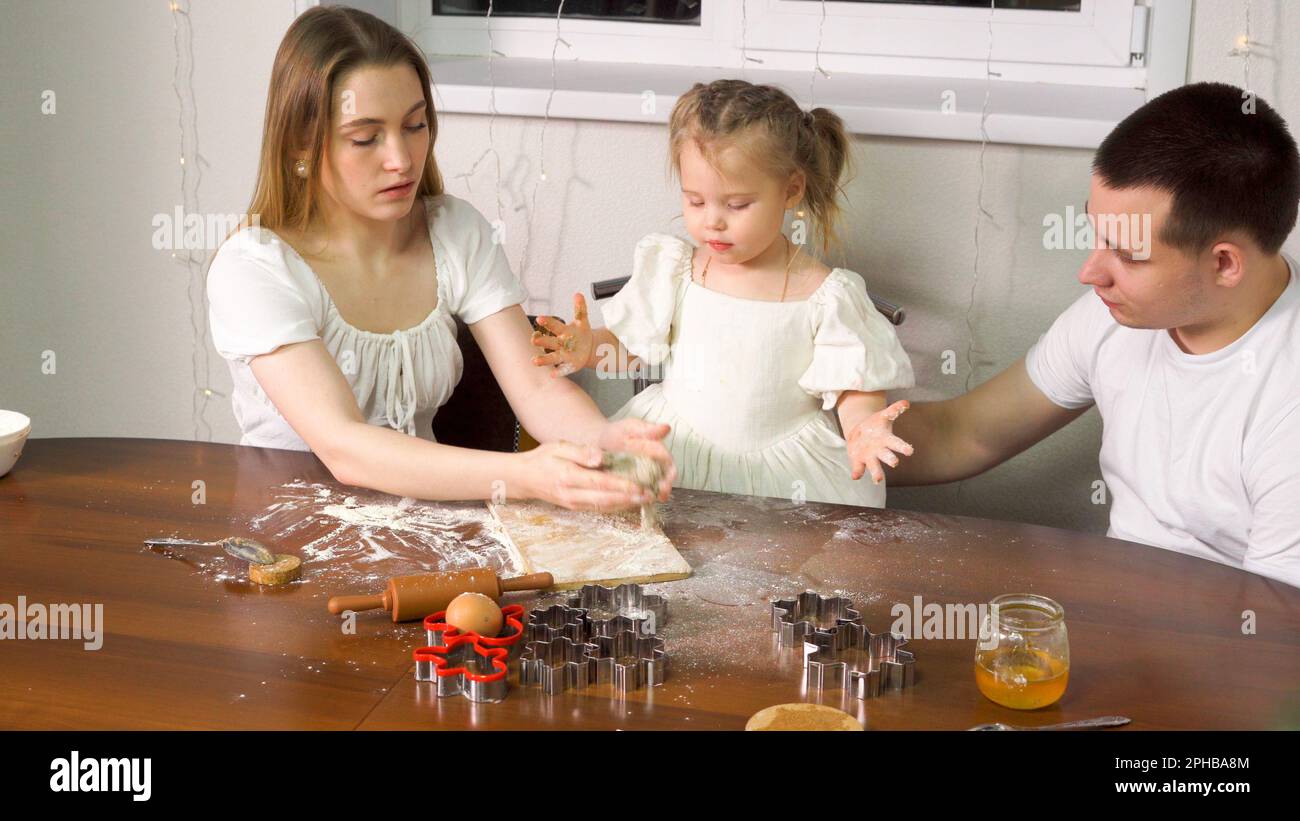 Happy family having fun with flour while cooking cookies Stock Photo ...