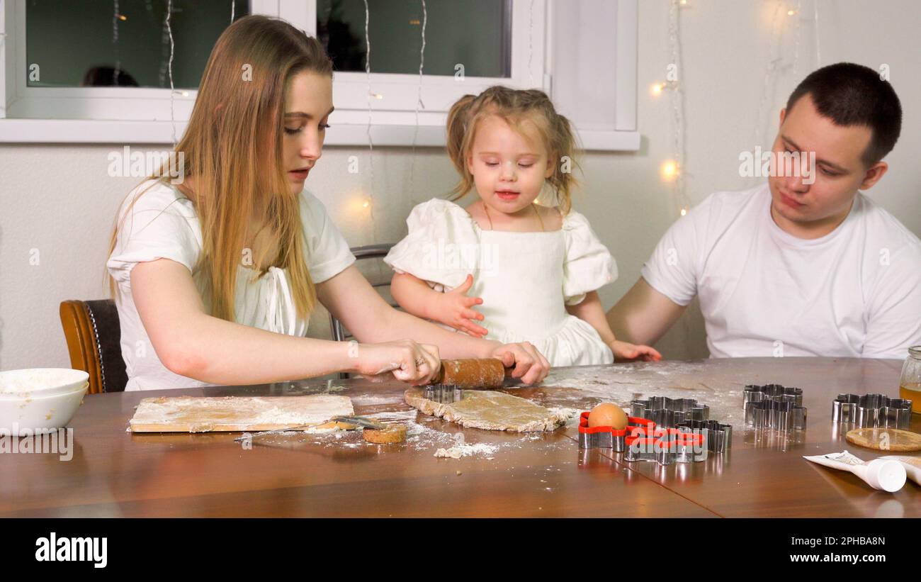 Happy family having fun with flour while cooking cookies Stock Photo ...