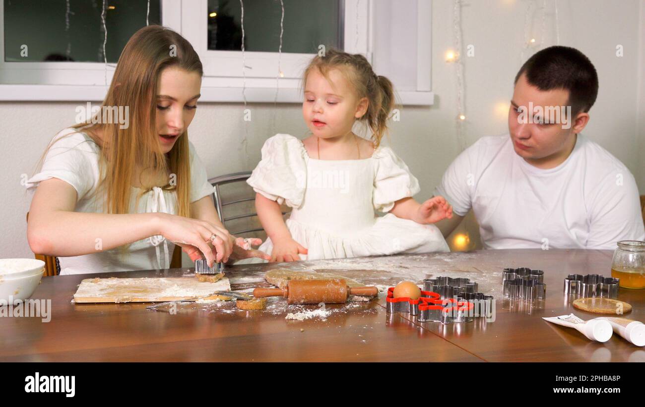 Happy family having fun with flour while cooking cookies Stock Photo ...