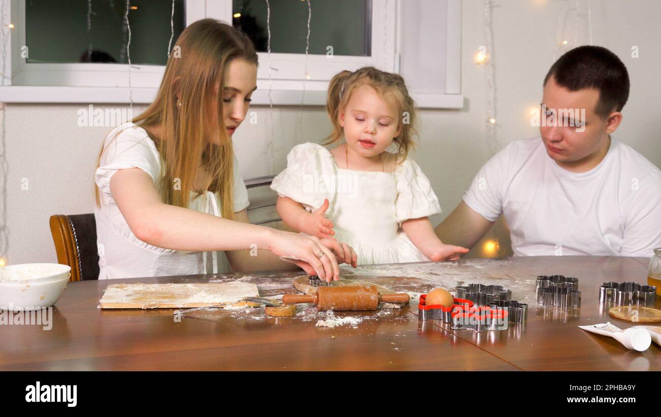 Happy family having fun with flour while cooking cookies Stock Photo ...