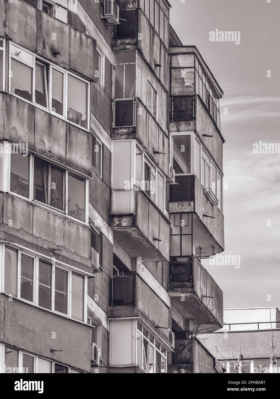 Worn out apartment building from the communist era against blue sky in ...
