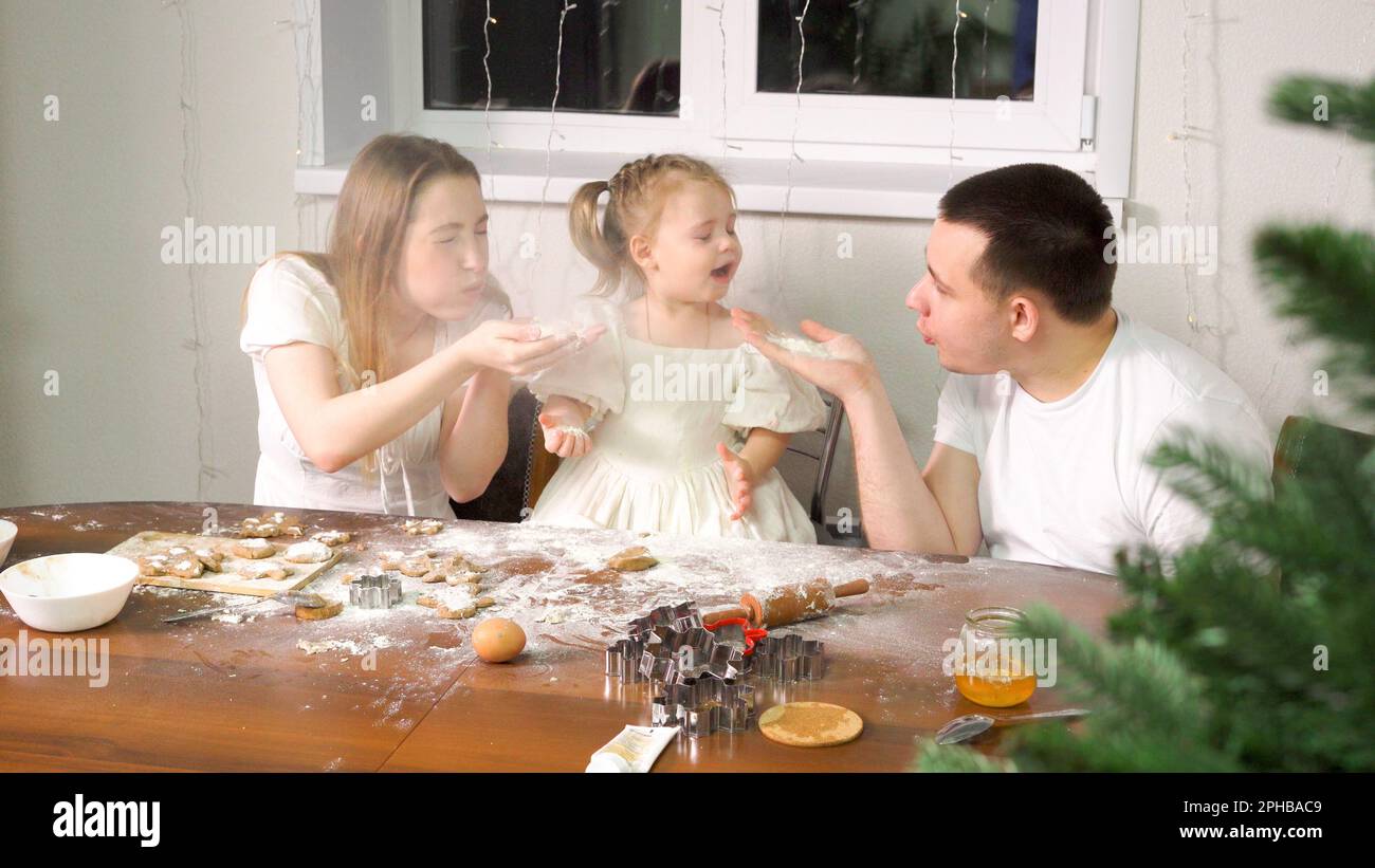 Happy family having fun with flour while cooking cookies Stock Photo ...