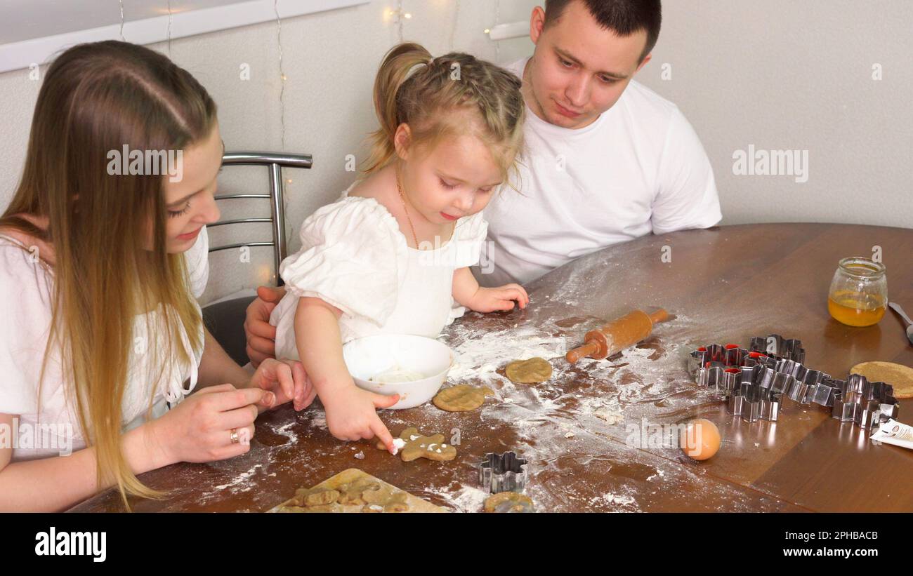 Happy family having fun with flour while cooking cookies Stock Photo ...