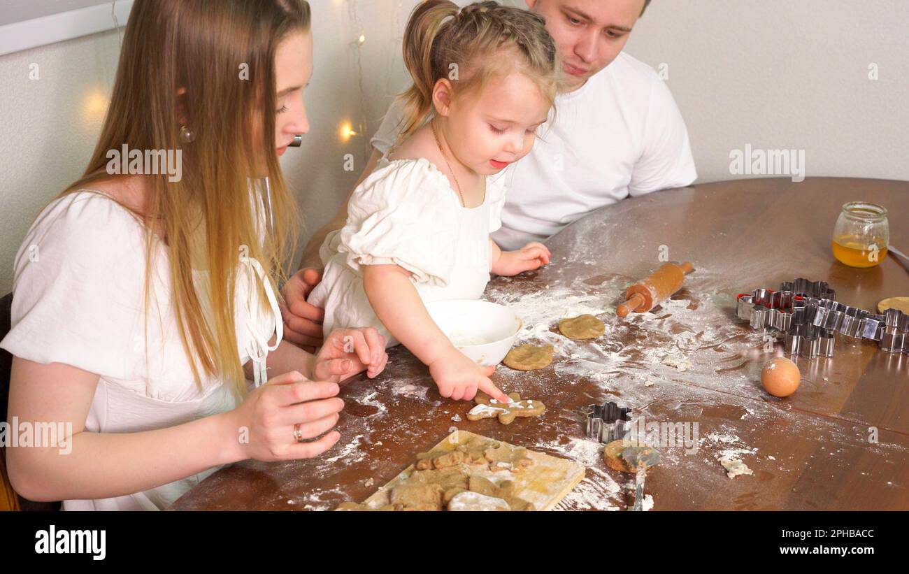 Happy family having fun with flour while cooking cookies Stock Photo ...