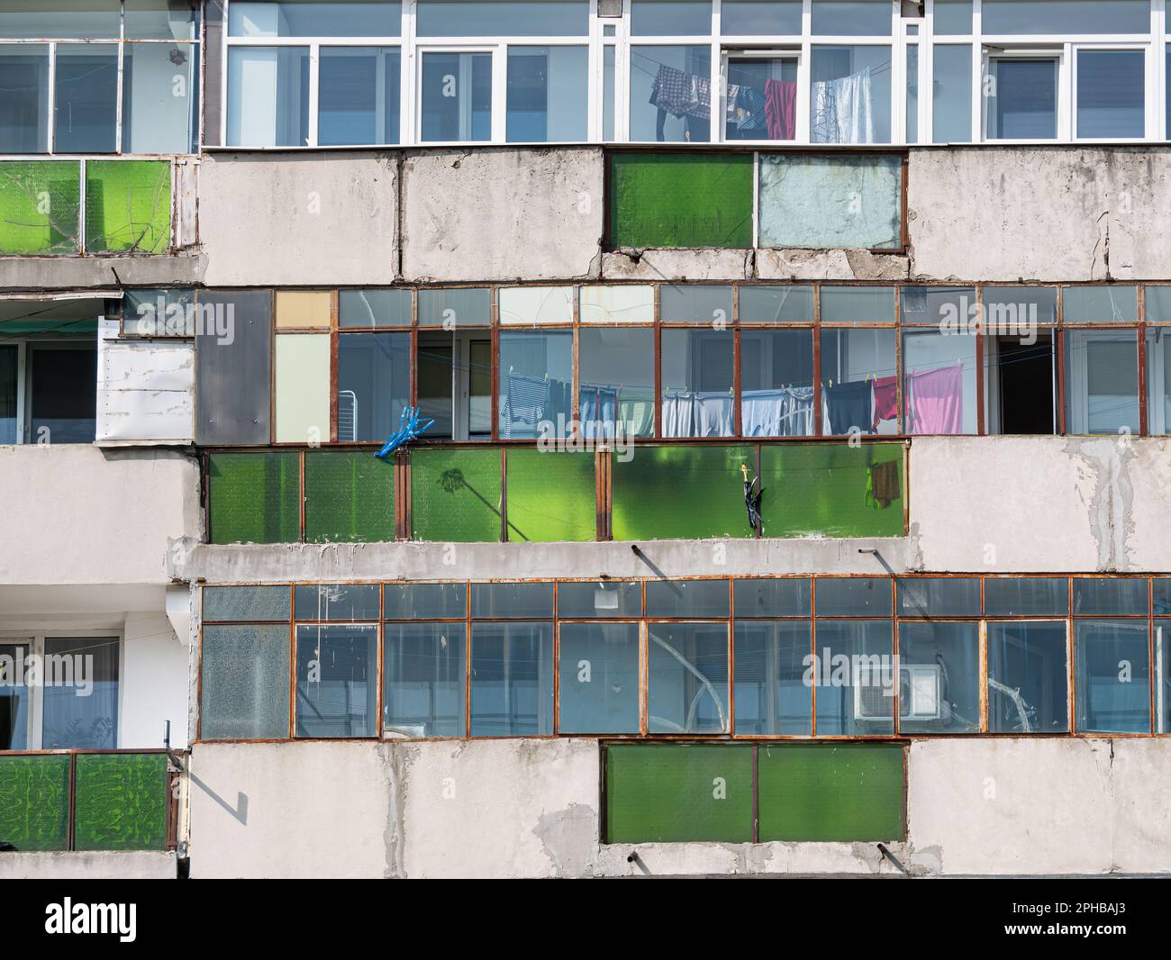 Worn out apartment building from the communist era against blue sky in ...