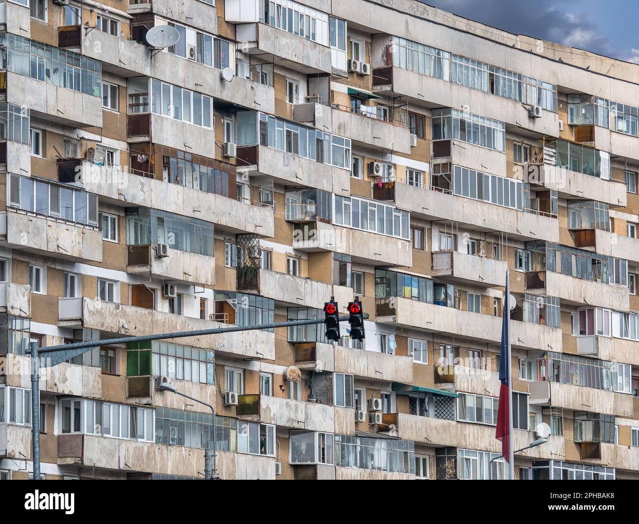 Worn out apartment building from the communist era against blue sky in ...