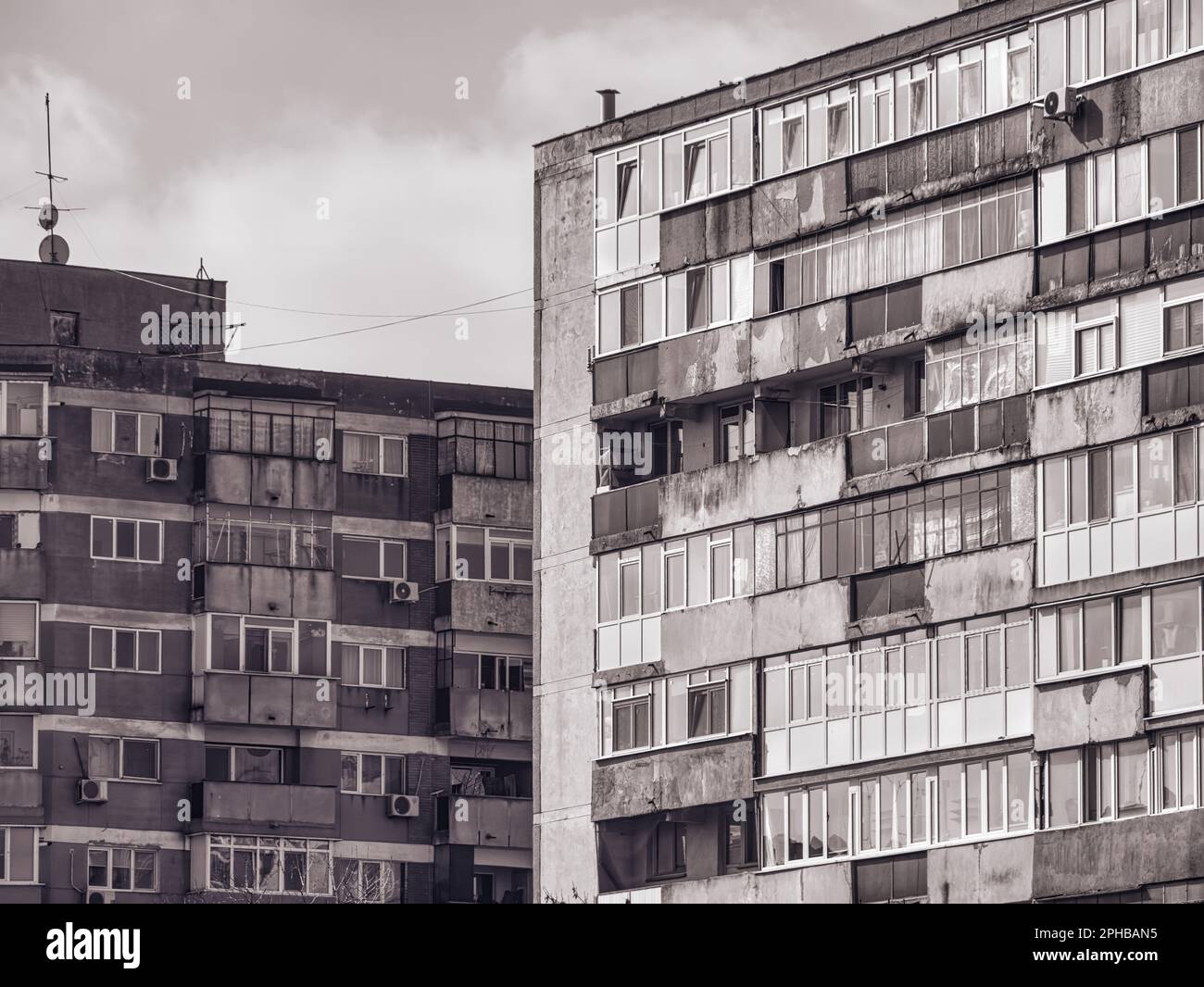 Worn out apartment building from the communist era against blue sky in ...