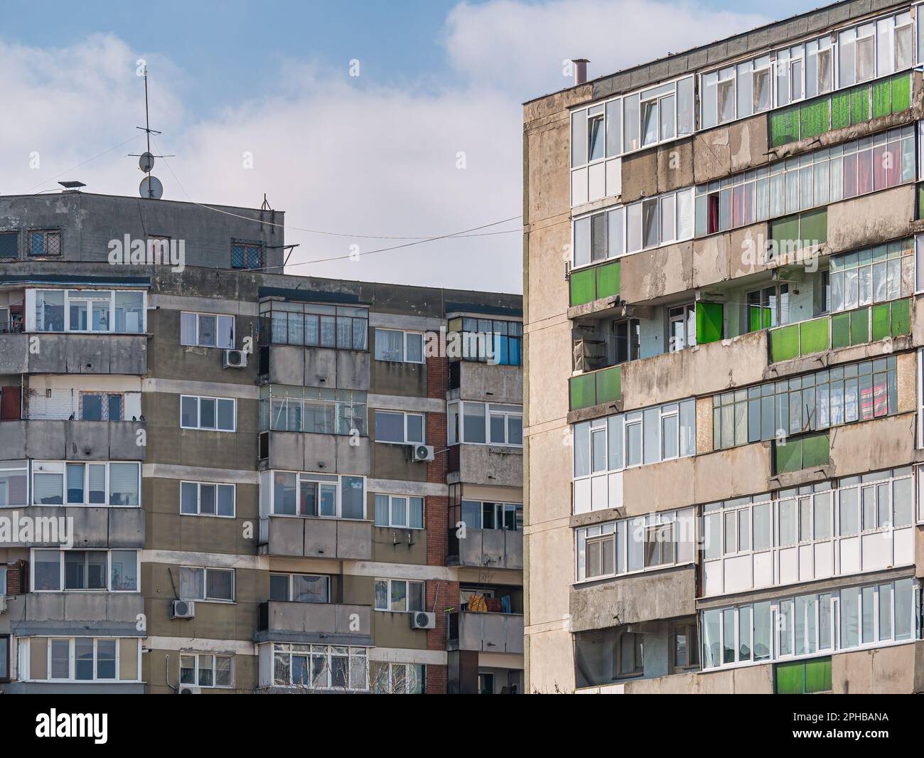 Worn out apartment building from the communist era against blue sky in ...