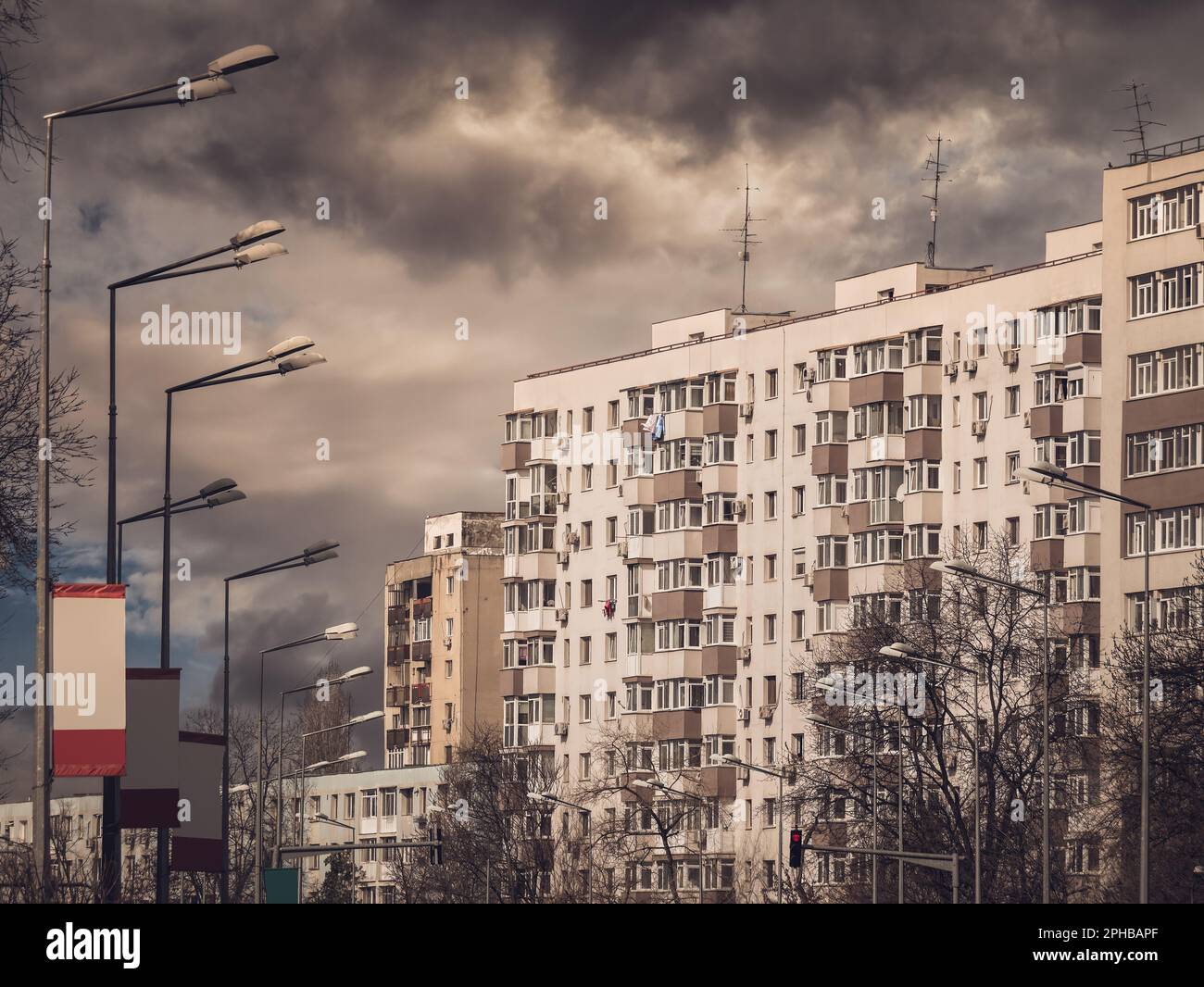Worn out apartment building from the communist era against blue sky in ...